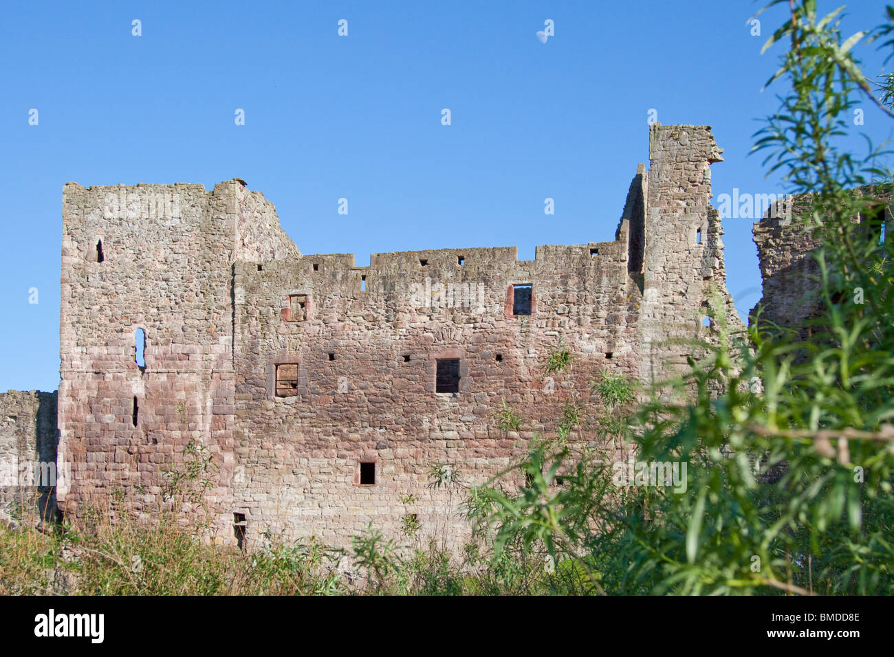 Hailes Castle in East Lothian in late afternoon sunshine. The moon in ...