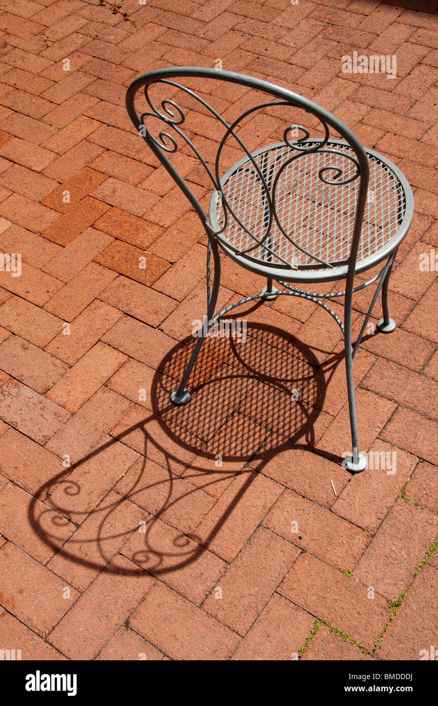 Metal chair casting shadow Stock Photo - Alamy