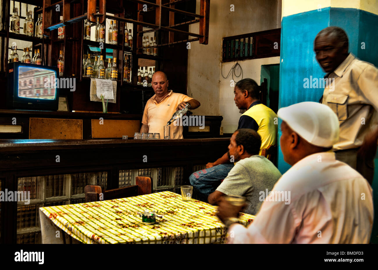 Inside local bar with men watching TV and drinking in Central Havana ...