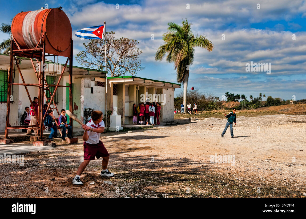 Students playing baseball outside school in Habana Province in ...