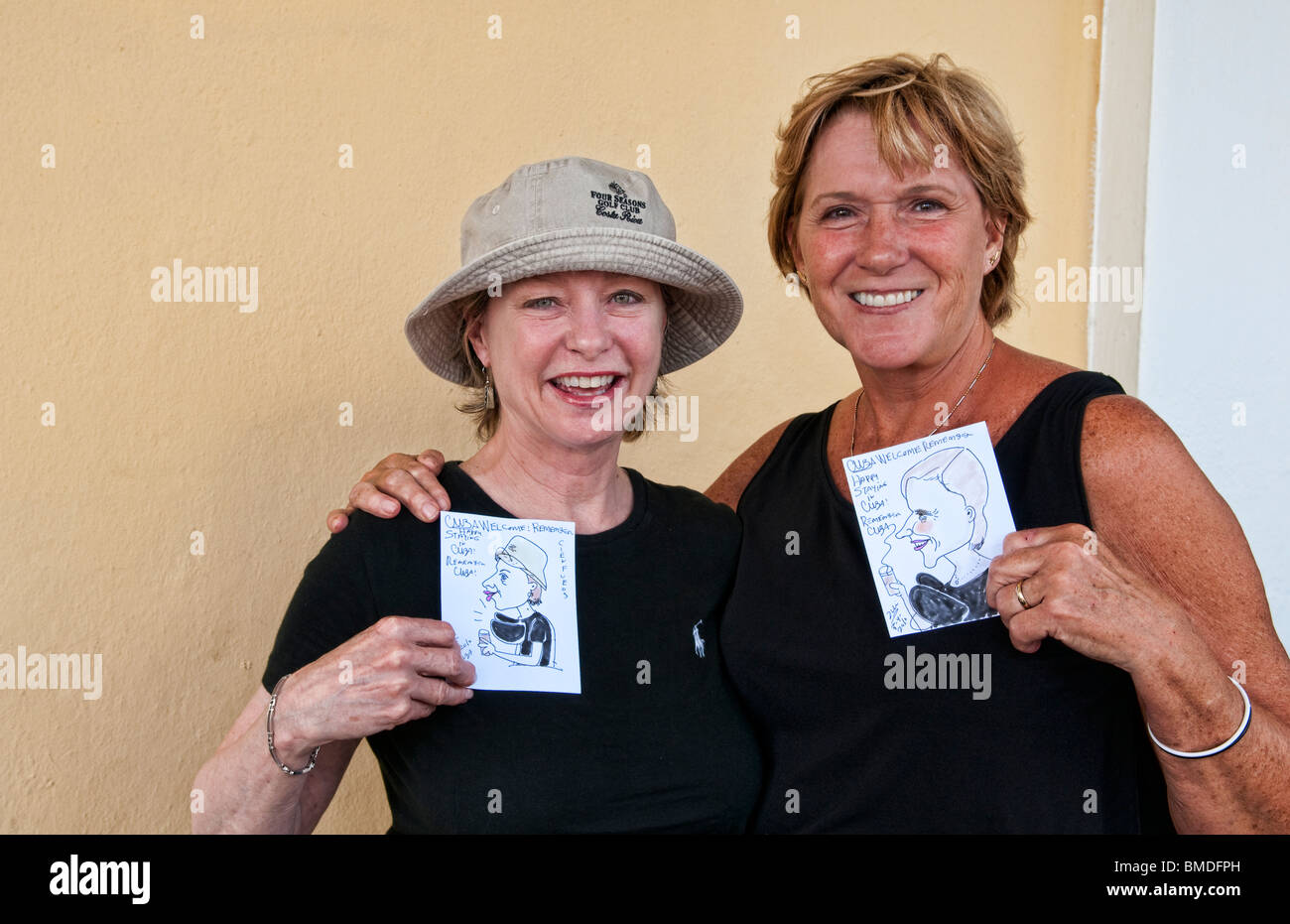 Two tourists showing off drawings of themselves in Cienfuegos Cuba ...