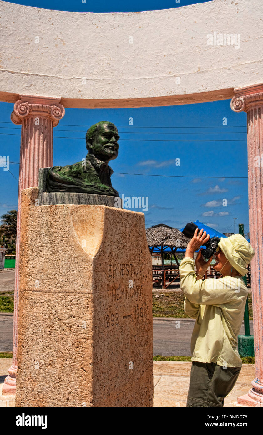 Attractive retired senior tourist lady with Hemingway bronze statue in ...