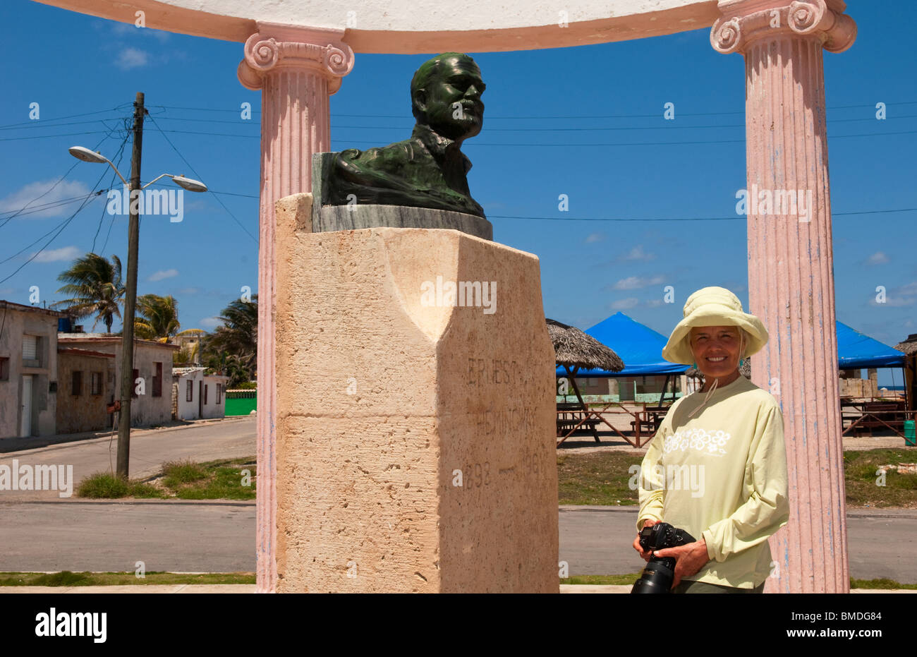 Attractive retired senior tourist lady with Hemingway bronze statue in ...