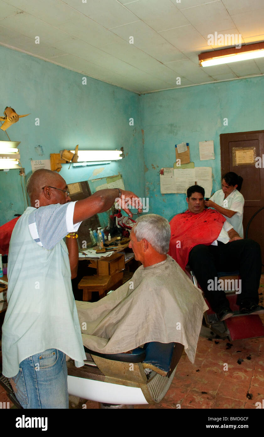 Small local barbershop with barber cutting hair in small town of ...