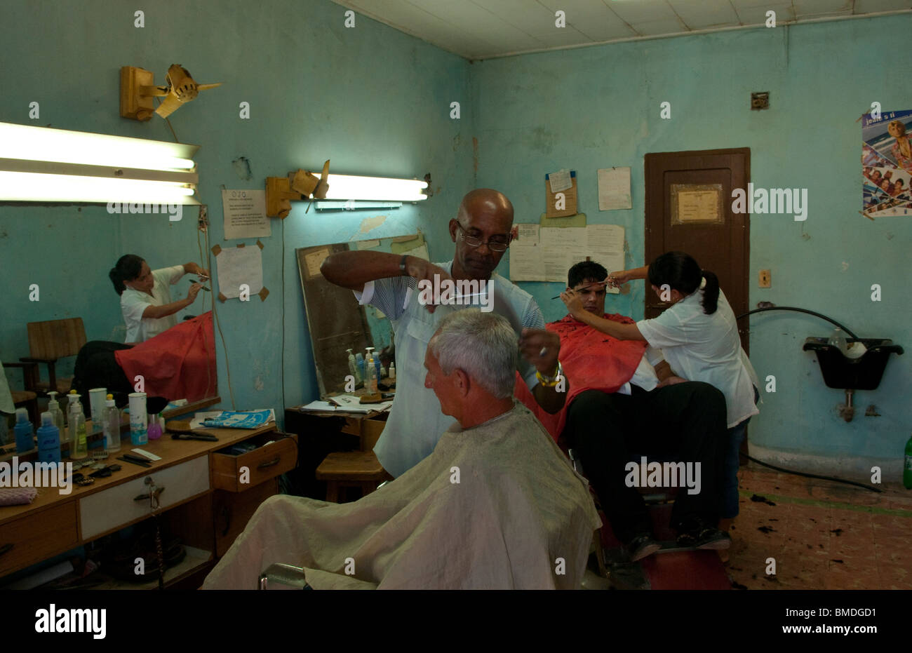 Small local barbershop with barber cutting hair in small town of ...