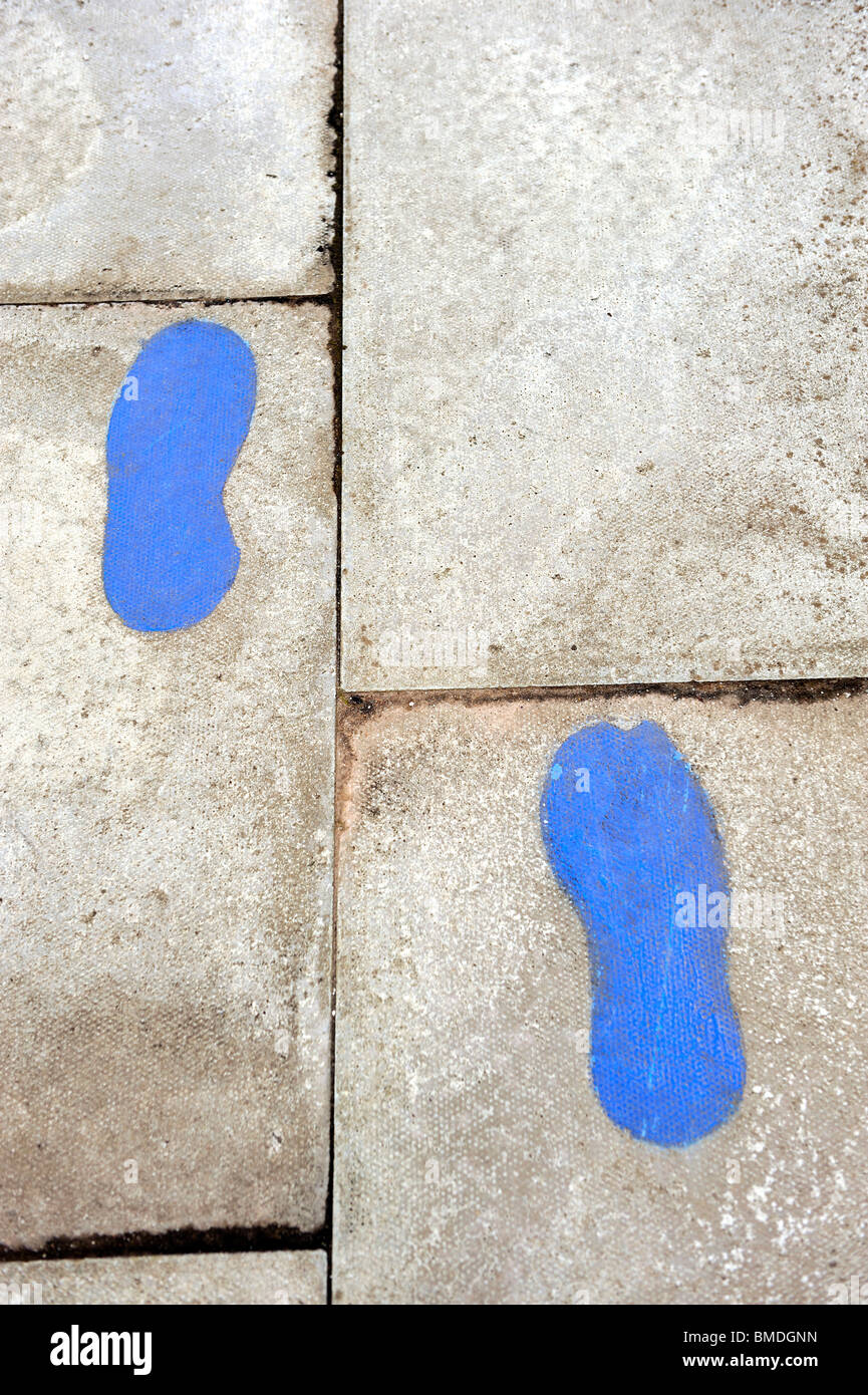 Blue footprints painted on pavement Stock Photo - Alamy
