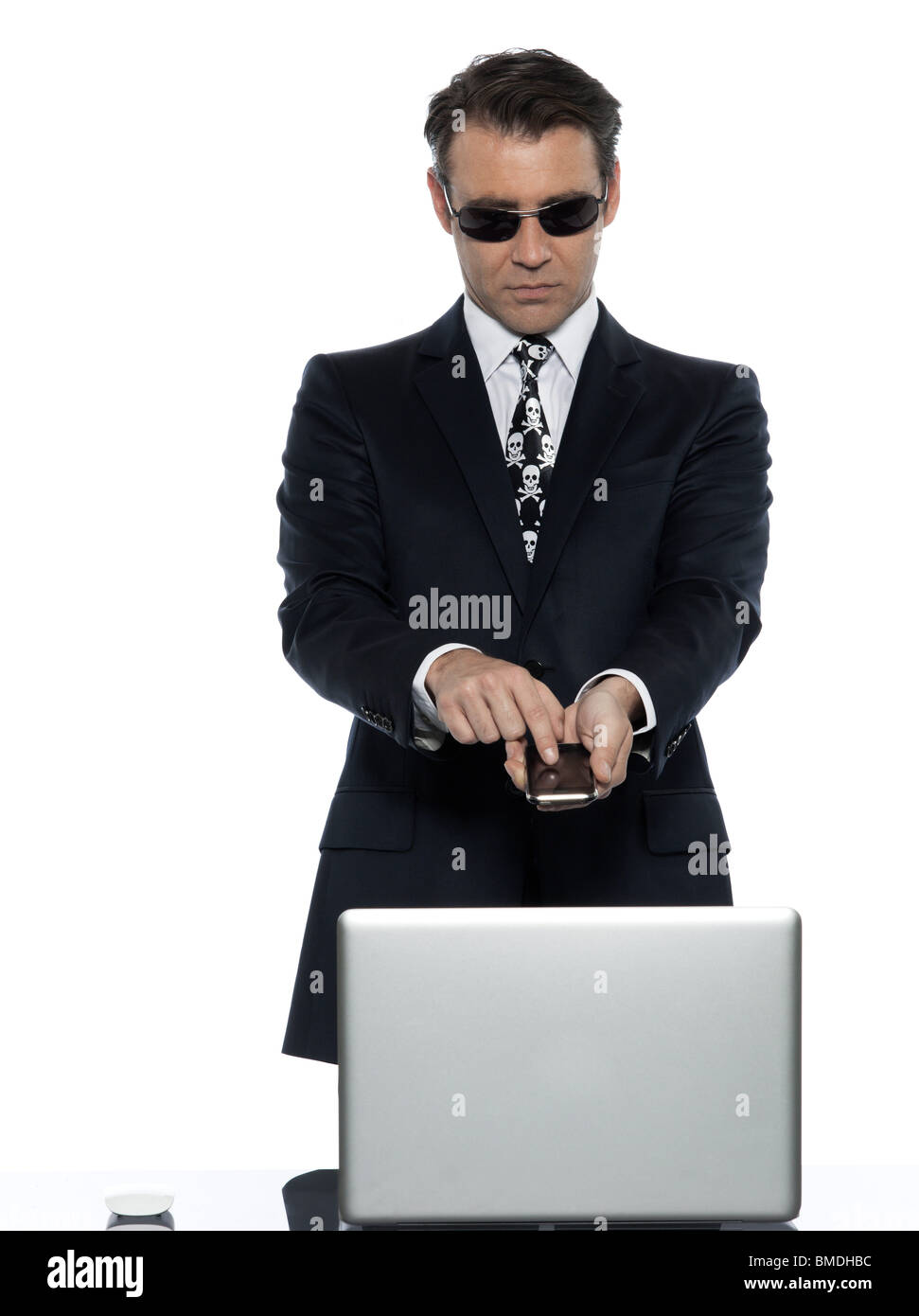 one criminal man computer hacker caucasian computing on the phone in ...