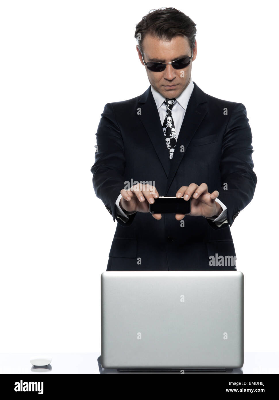 one criminal man computer hacker caucasian computing on the phone in ...