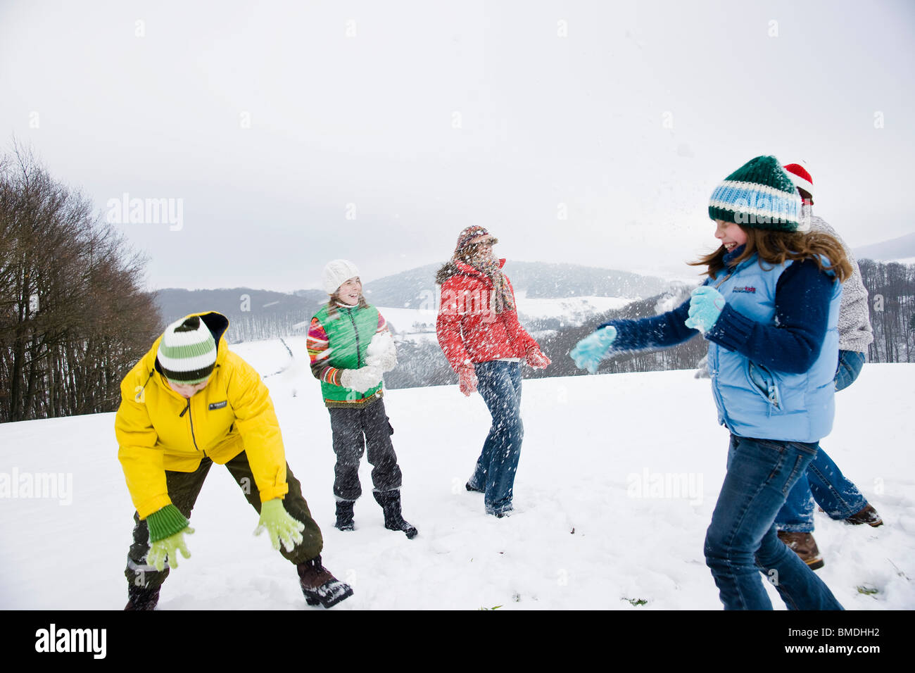 Family Having Snowball Fight Stock Photo - Alamy