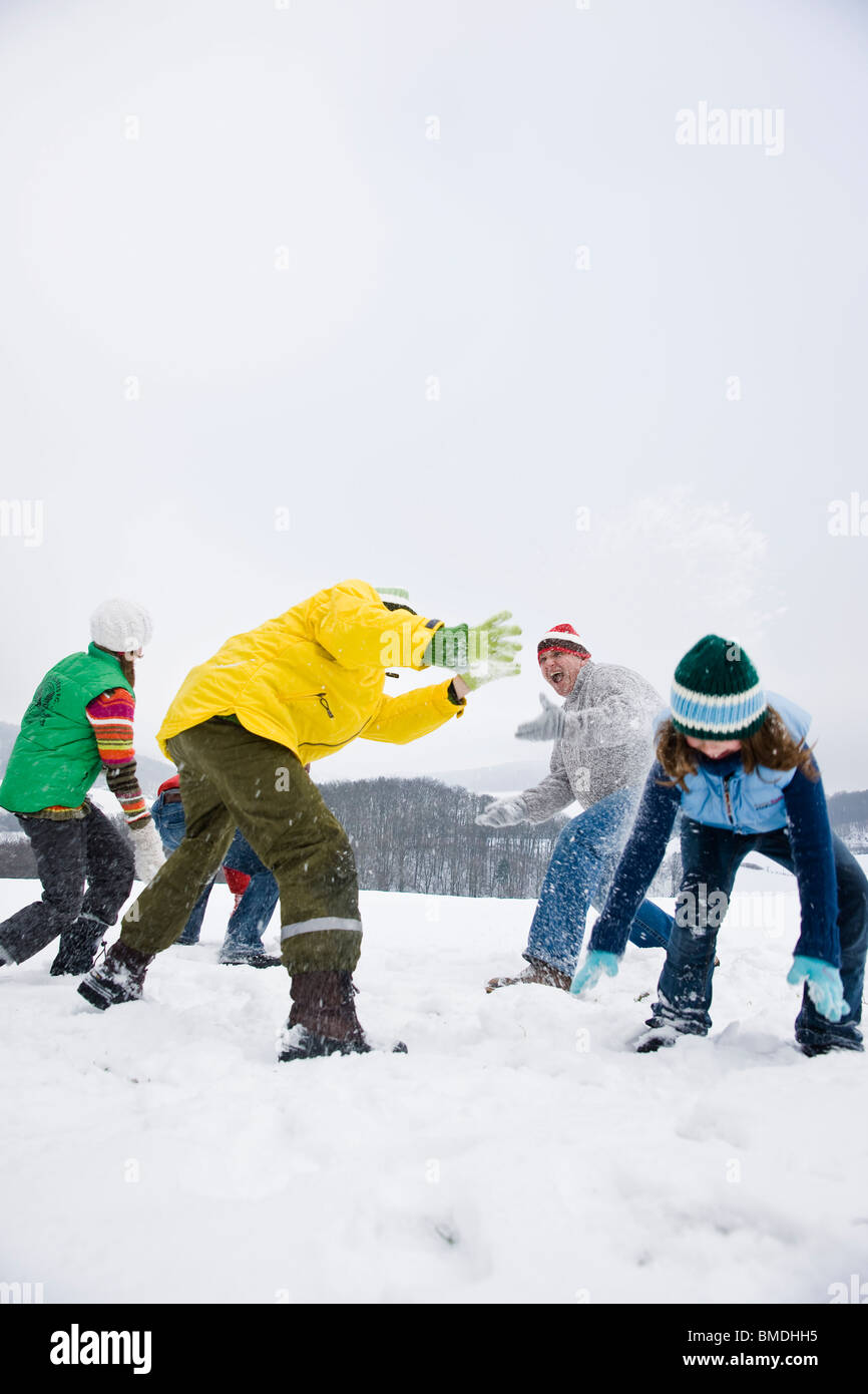 Family Having Snowball Fight Stock Photo - Alamy