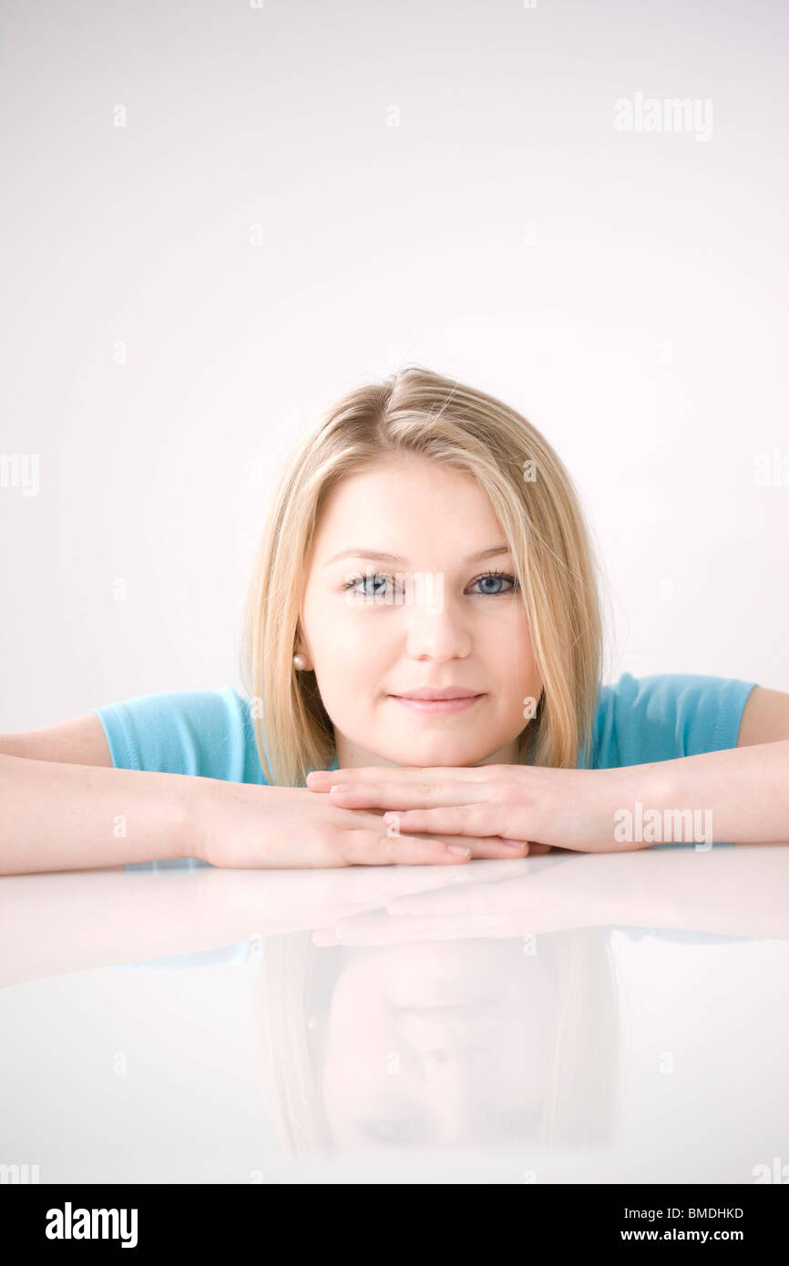 Woman Resting Head on Hands Stock Photo - Alamy