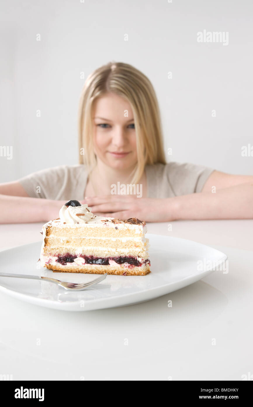 Woman Staring at Piece of Cake Stock Photo - Alamy