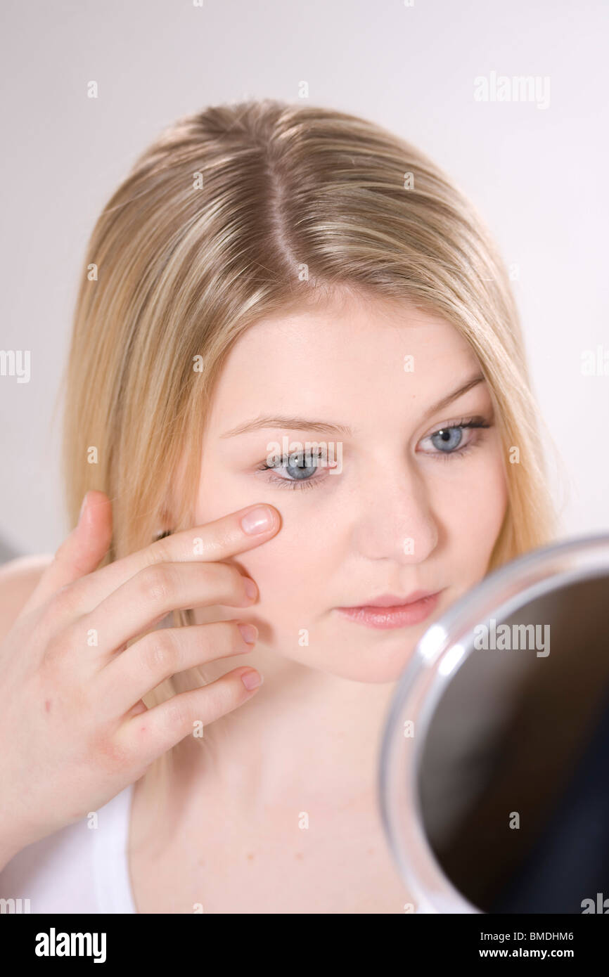 Woman Looking in Mirror Stock Photo - Alamy
