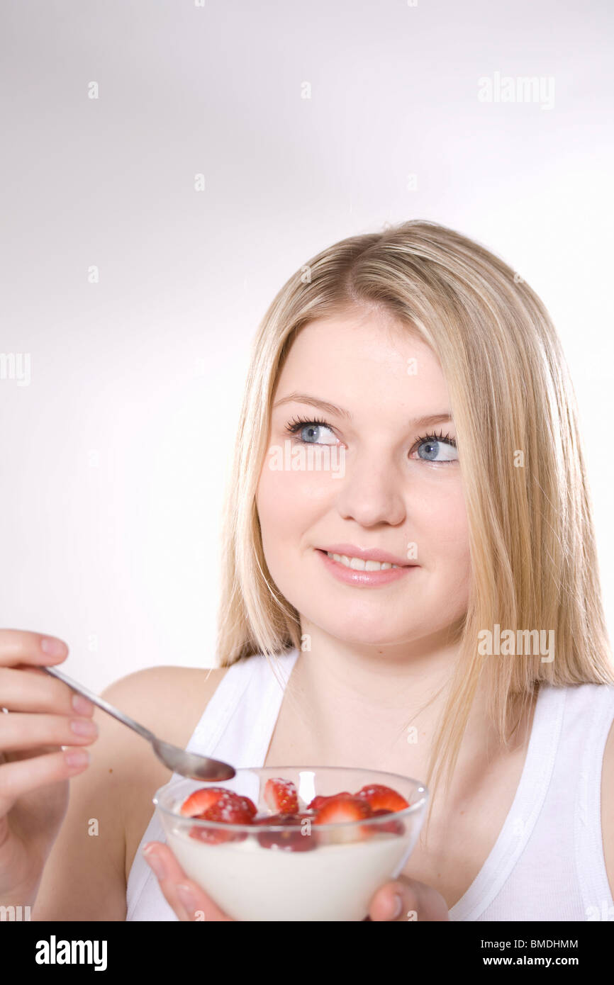 Woman Eating Strawberries and Cream Stock Photo - Alamy