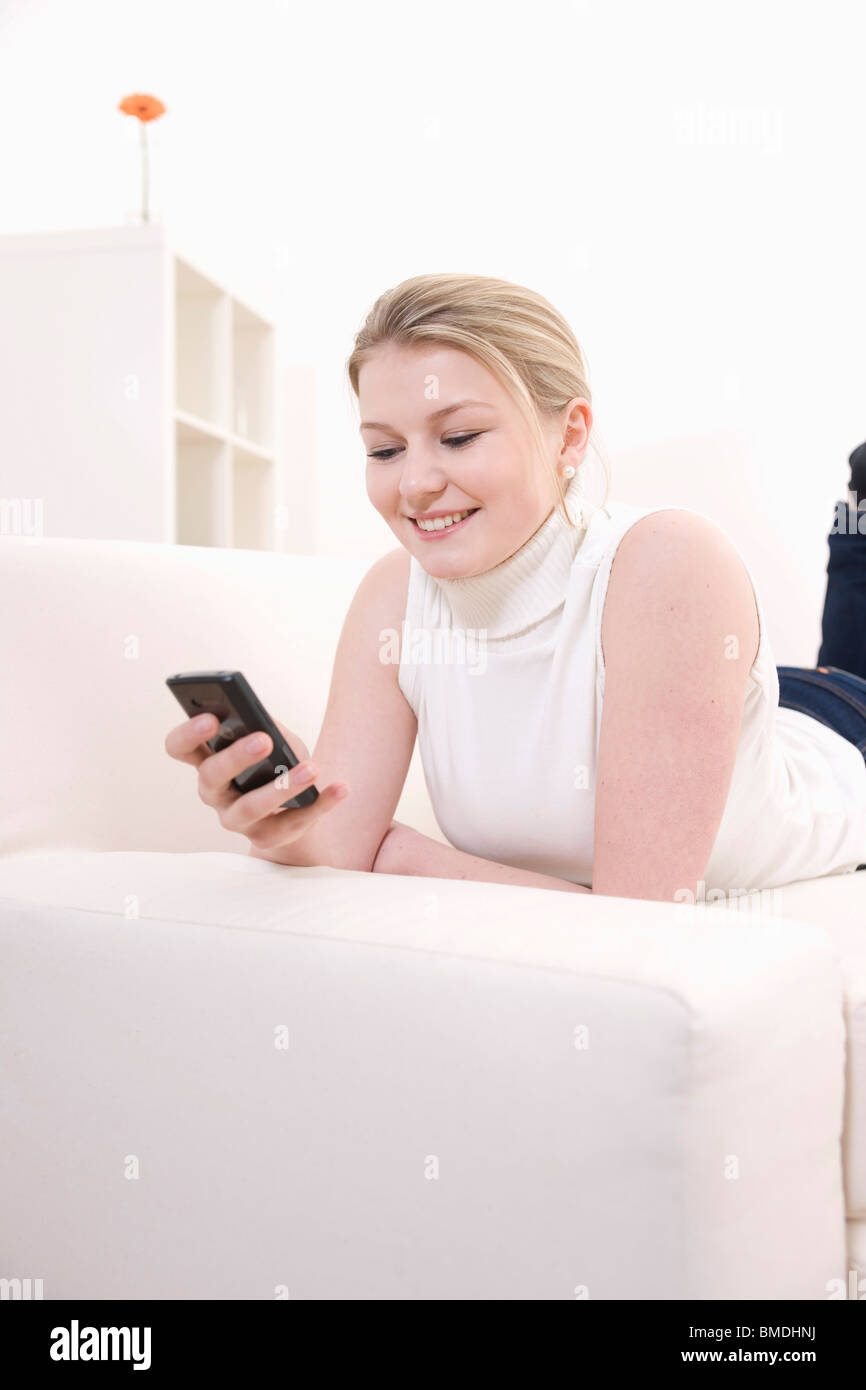 Young ladies using phone holding hi-res stock photography and images ...