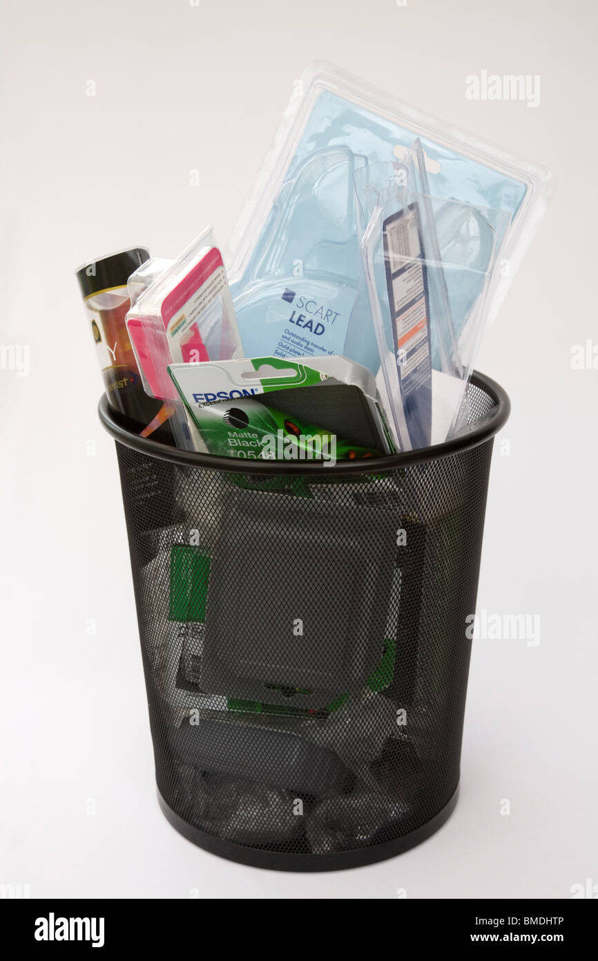 Waste bin full of single use plastic packaging thrown out on a plain ...