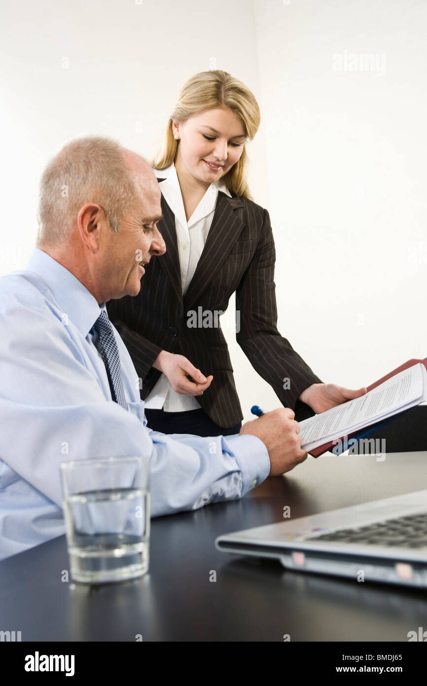 Middle aged people signing papers hi-res stock photography and images ...