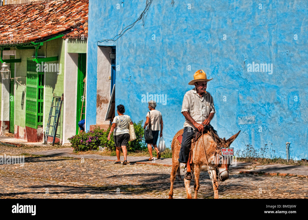 Old man riding donkey on cobblestone streets of Trinidad Cuba Stock ...