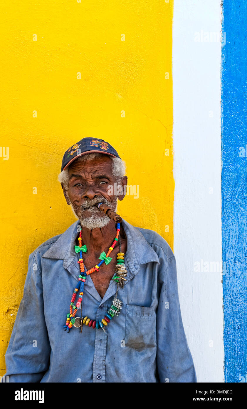 Colorful local man on yellow wall in colorful Trinidad Cuba Colonial ...