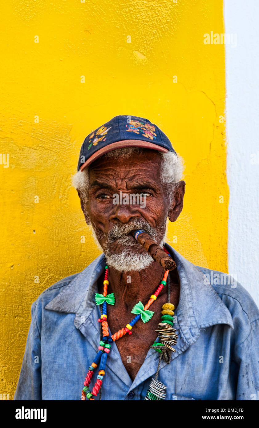 Colorful local man on yellow wall in colorful Trinidad Cuba Colonial ...