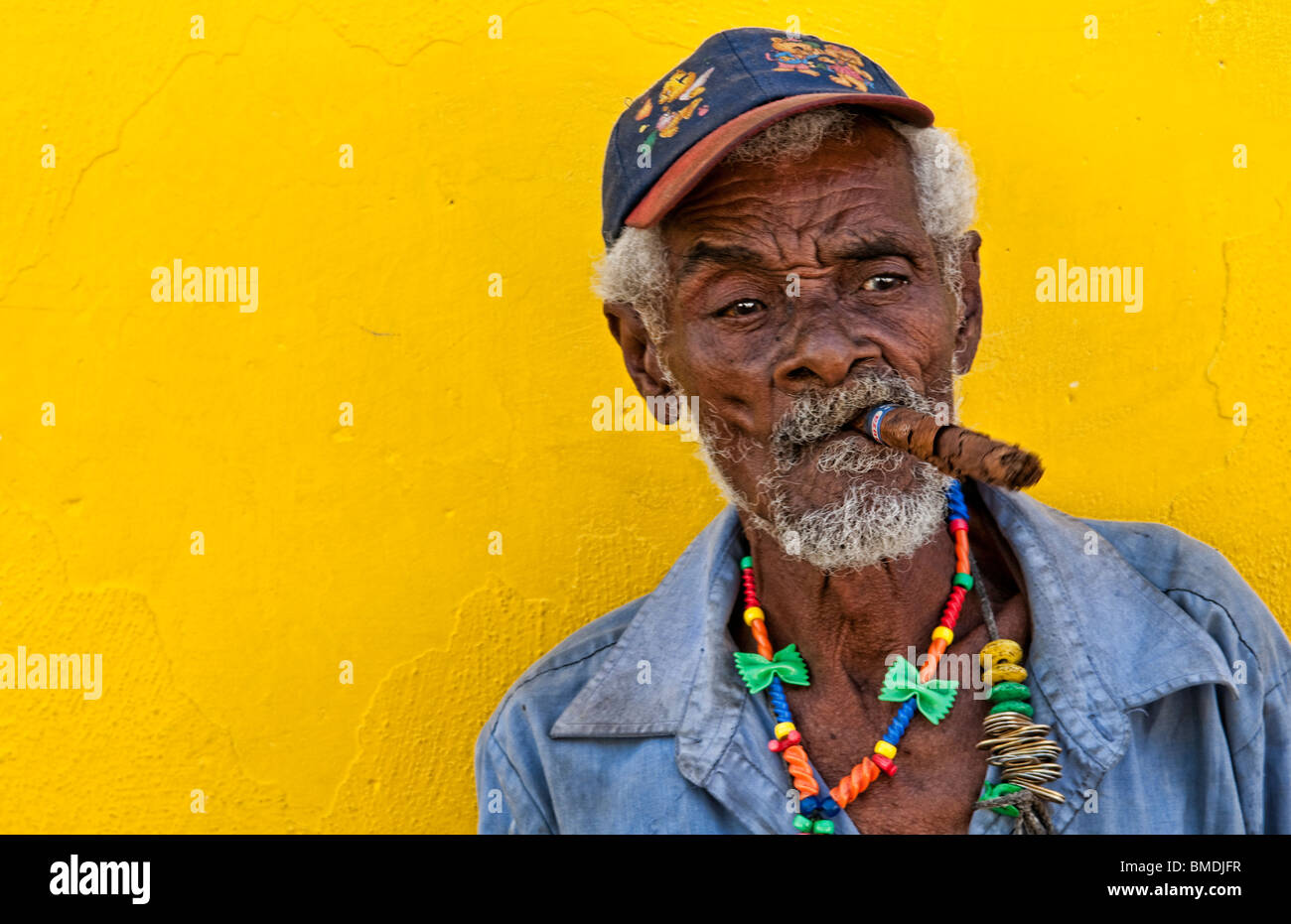 Colorful local man on yellow wall in colorful Trinidad Cuba Colonial ...