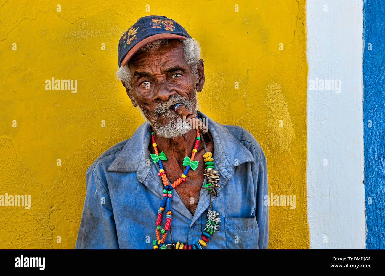 Colorful local man on yellow wall in colorful Trinidad Cuba Colonial ...