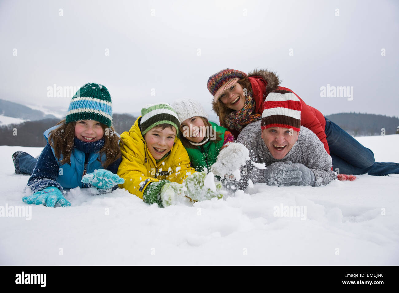 Portrait of Family Playing in Snow Stock Photo - Alamy