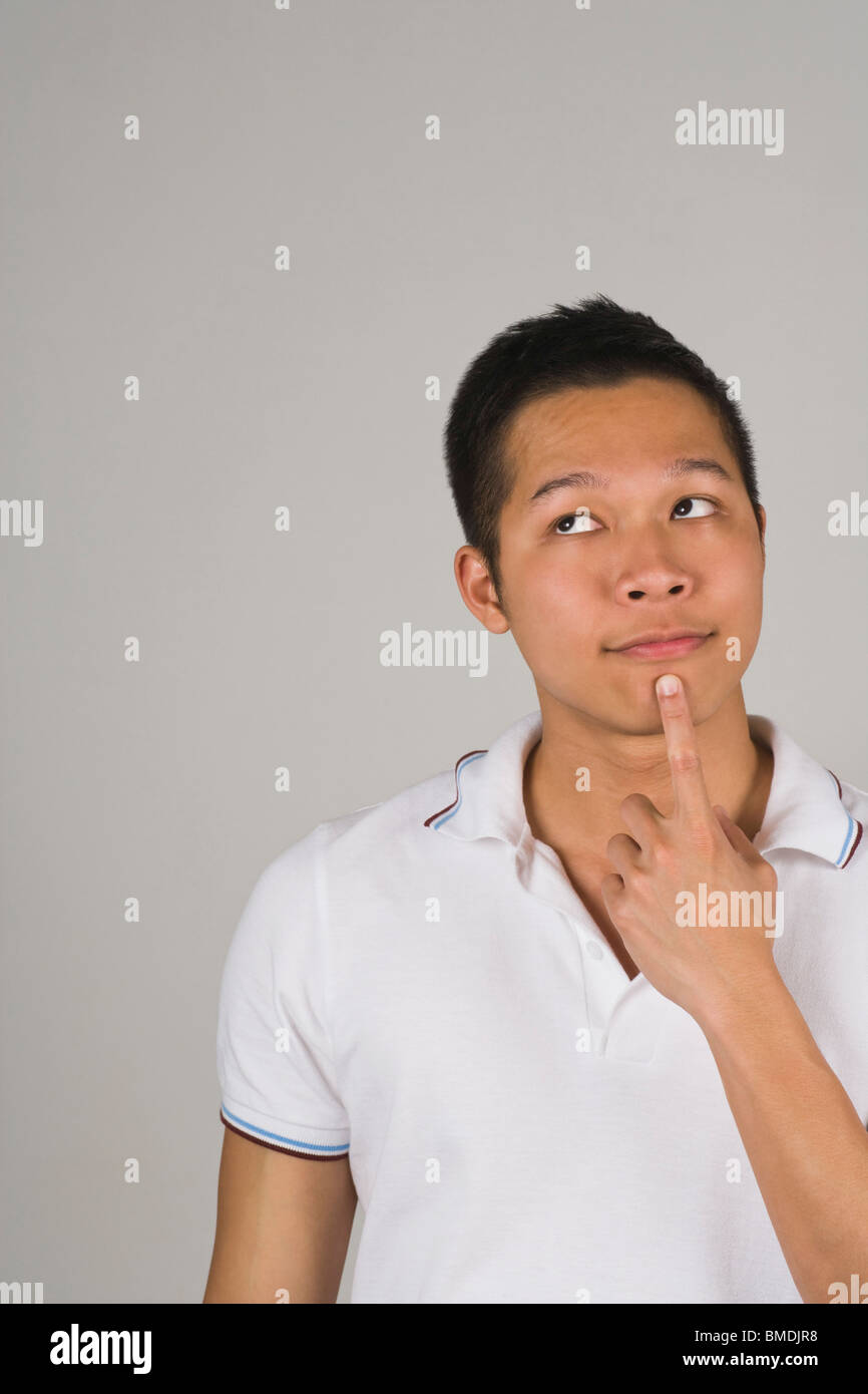 Man with Finger on Chin Stock Photo - Alamy