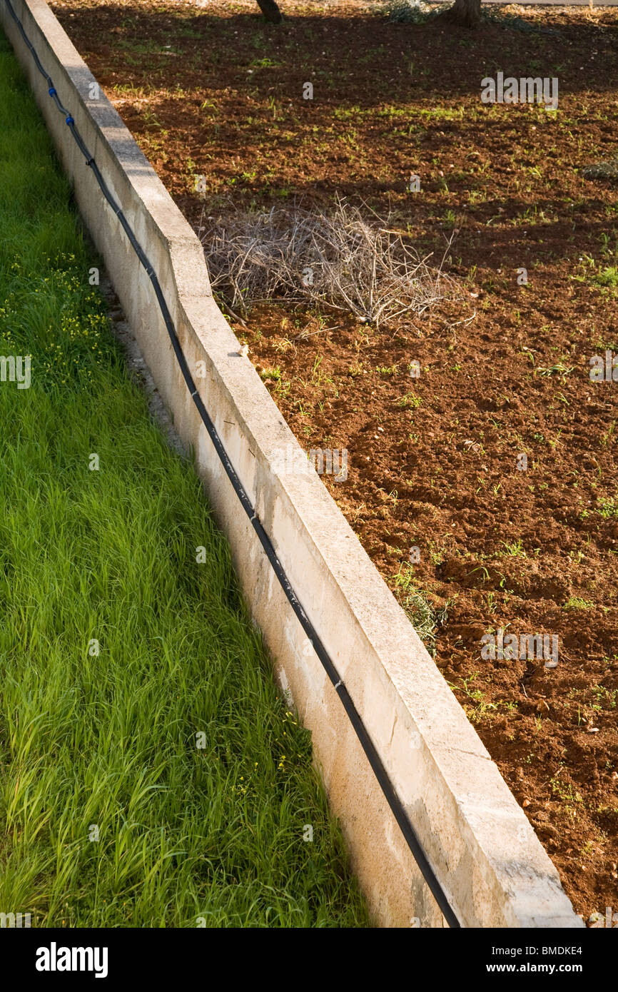 Wall dividing land Stock Photo - Alamy