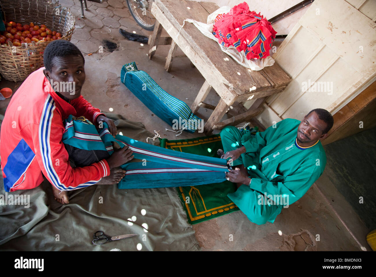 Two Fulani men in the market in Segou, Mali measure out long strips of ...