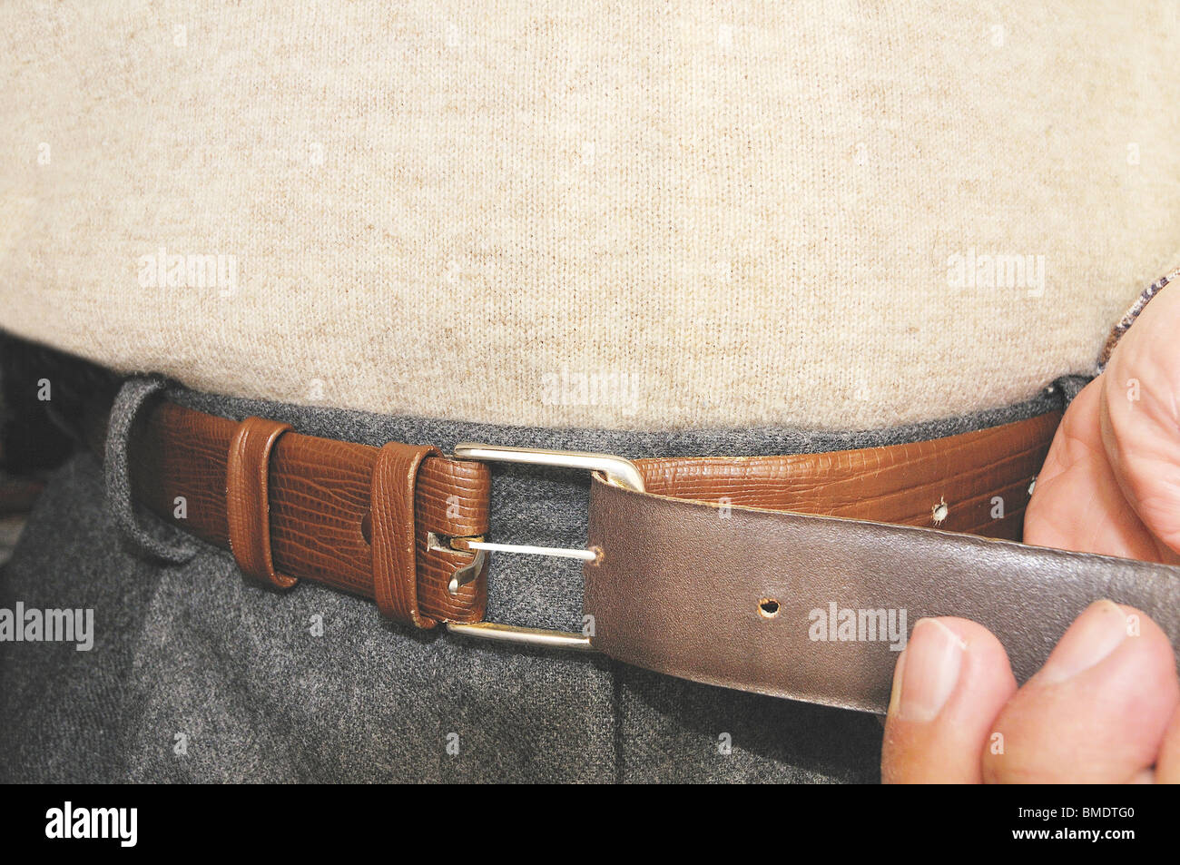 Squeezing the belt Stock Photo - Alamy