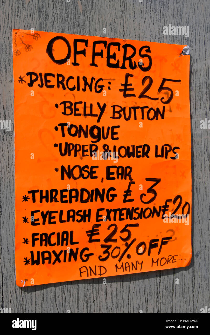 handwritten poster advertising body piercing, waxing, facials and more ...