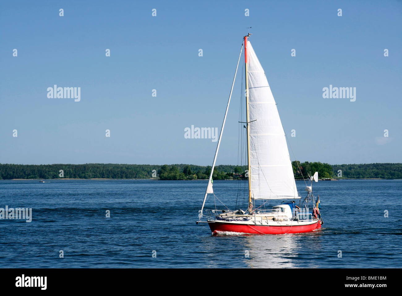 A small sailing boat in blue and calm sea Stock Photo - Alamy