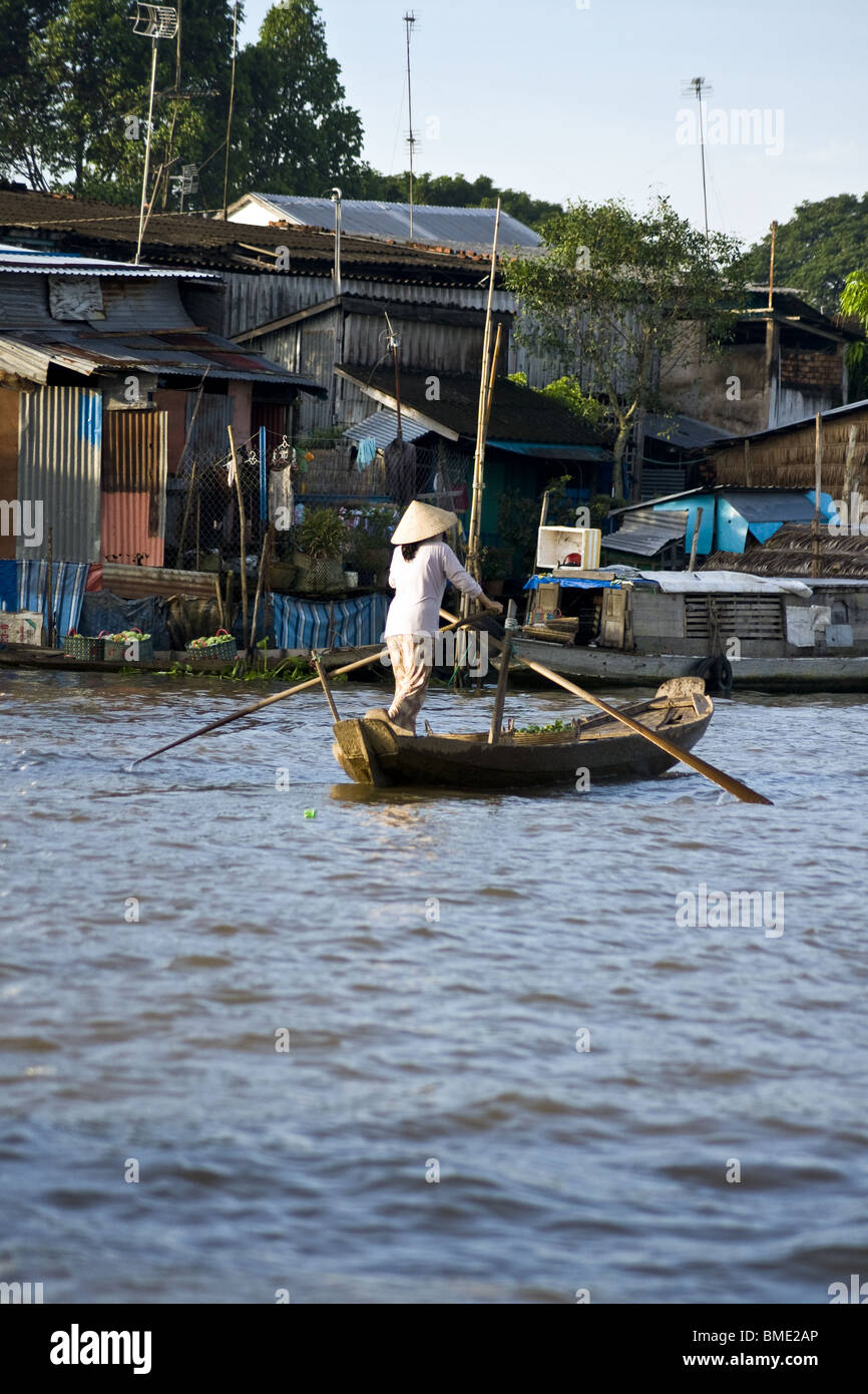 Vietnamese woman rowing boat on Mekong Delta Stock Photo - Alamy