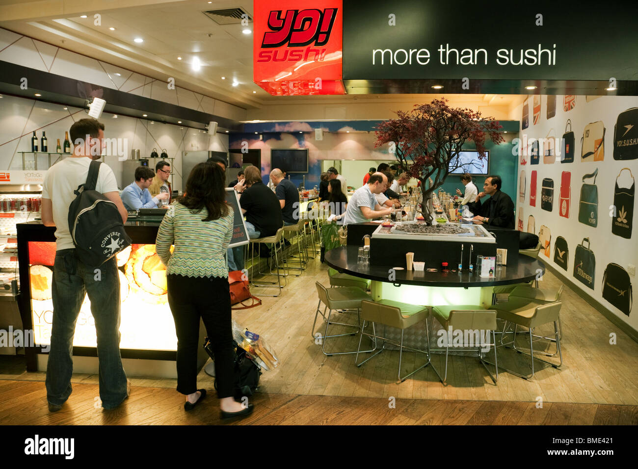 Customers at the Yo Sushi cafe, Terminal 3, Heathrow Airport London UK ...