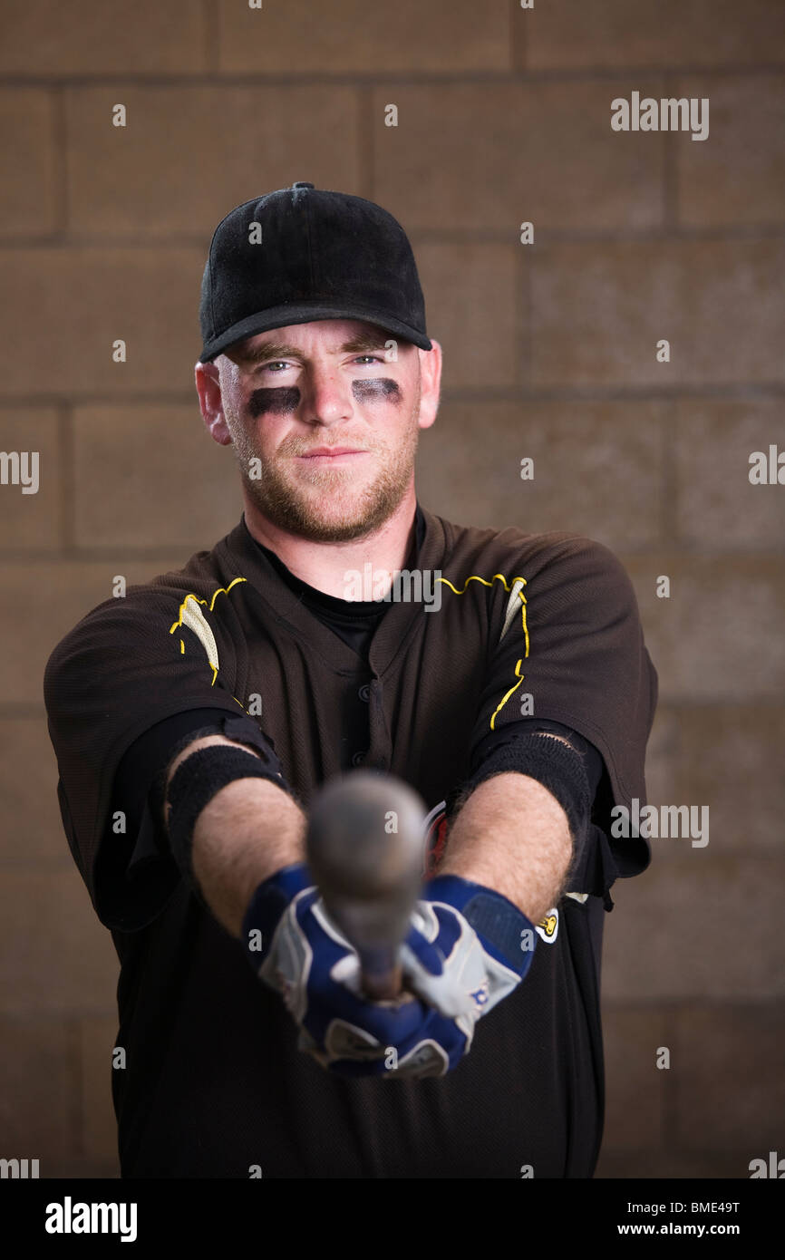 Baseball player pointing bat at viewer Stock Photo - Alamy
