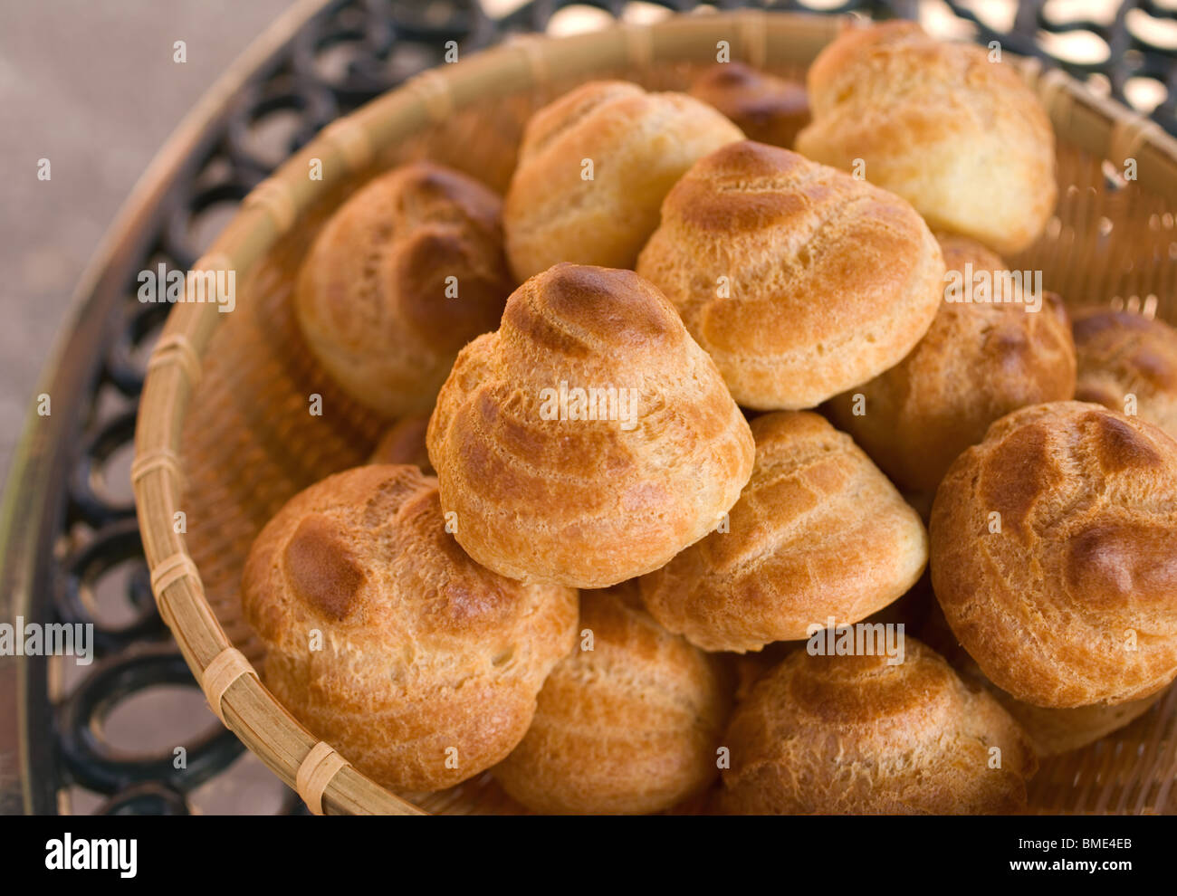 Chou pastries in a wicker basket Stock Photo - Alamy