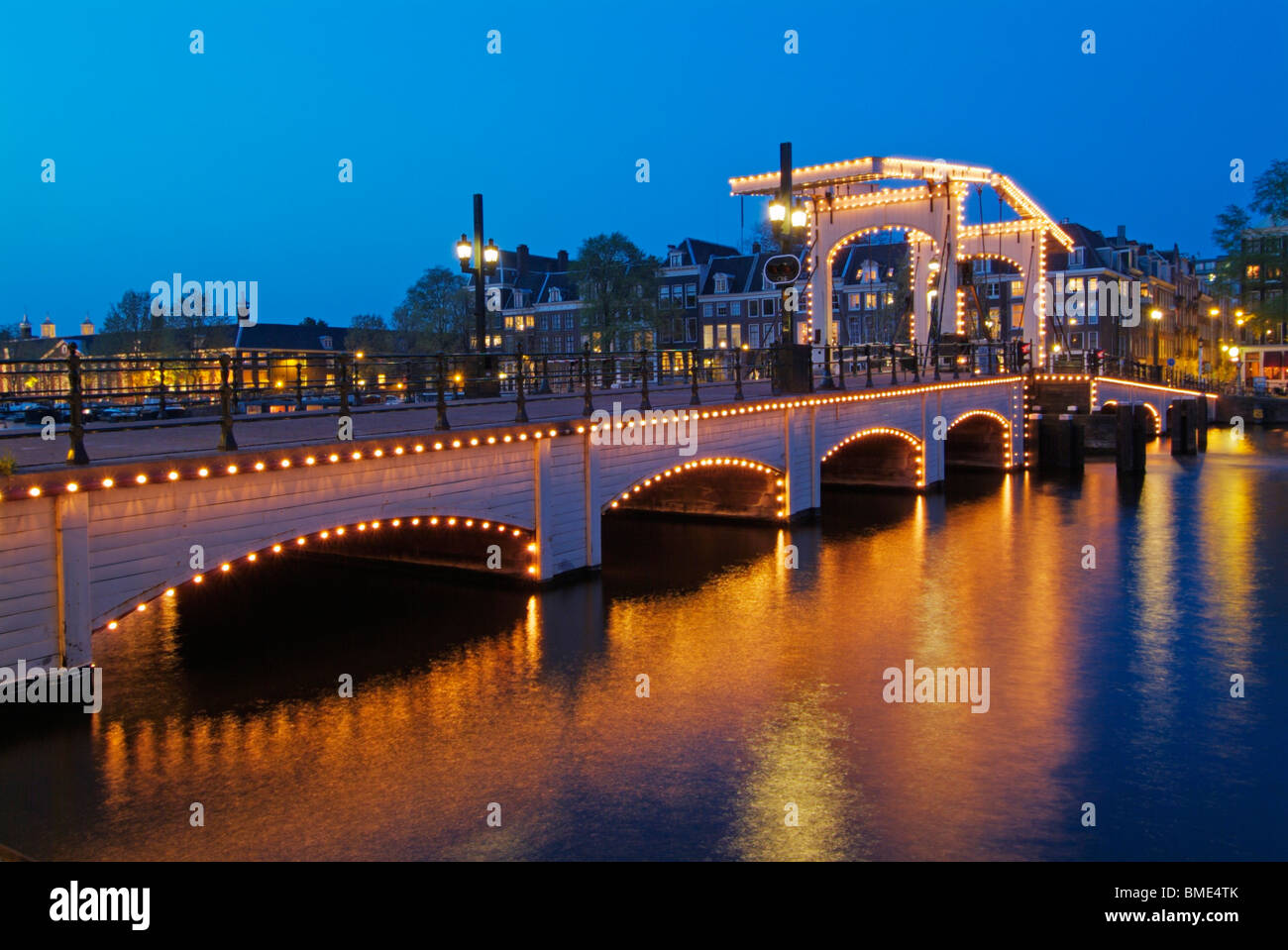 Magere brug or "Skinny bridge" at night double drawbridge spanning the ...