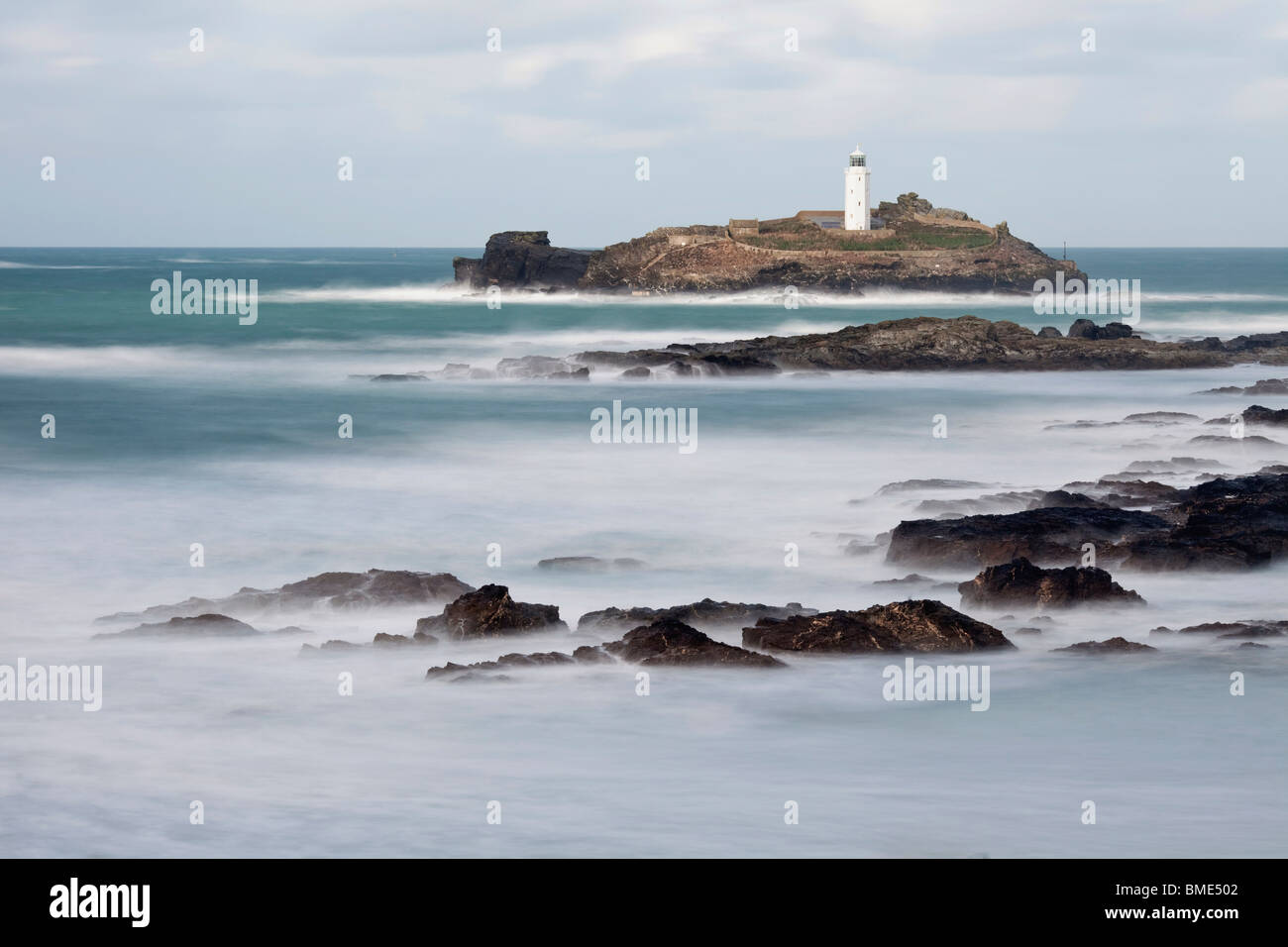 White lighthouse with misty water to foreground Stock Photo - Alamy