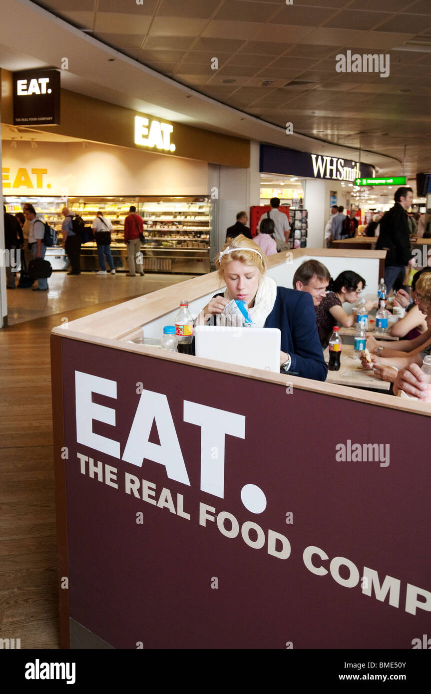 Customers eating at the Eat cafe, Terminal 3 departure lounge, Heathrow ...