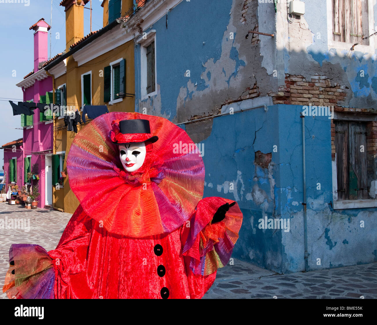 Clown walking the streets of Burano, Italy during the Venice Carnival ...