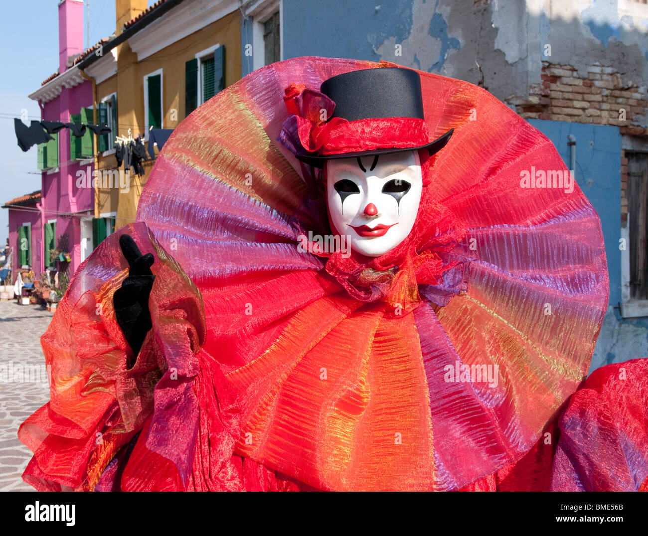 Clown walking the streets of Burano, Italy during the Venice Carnival ...