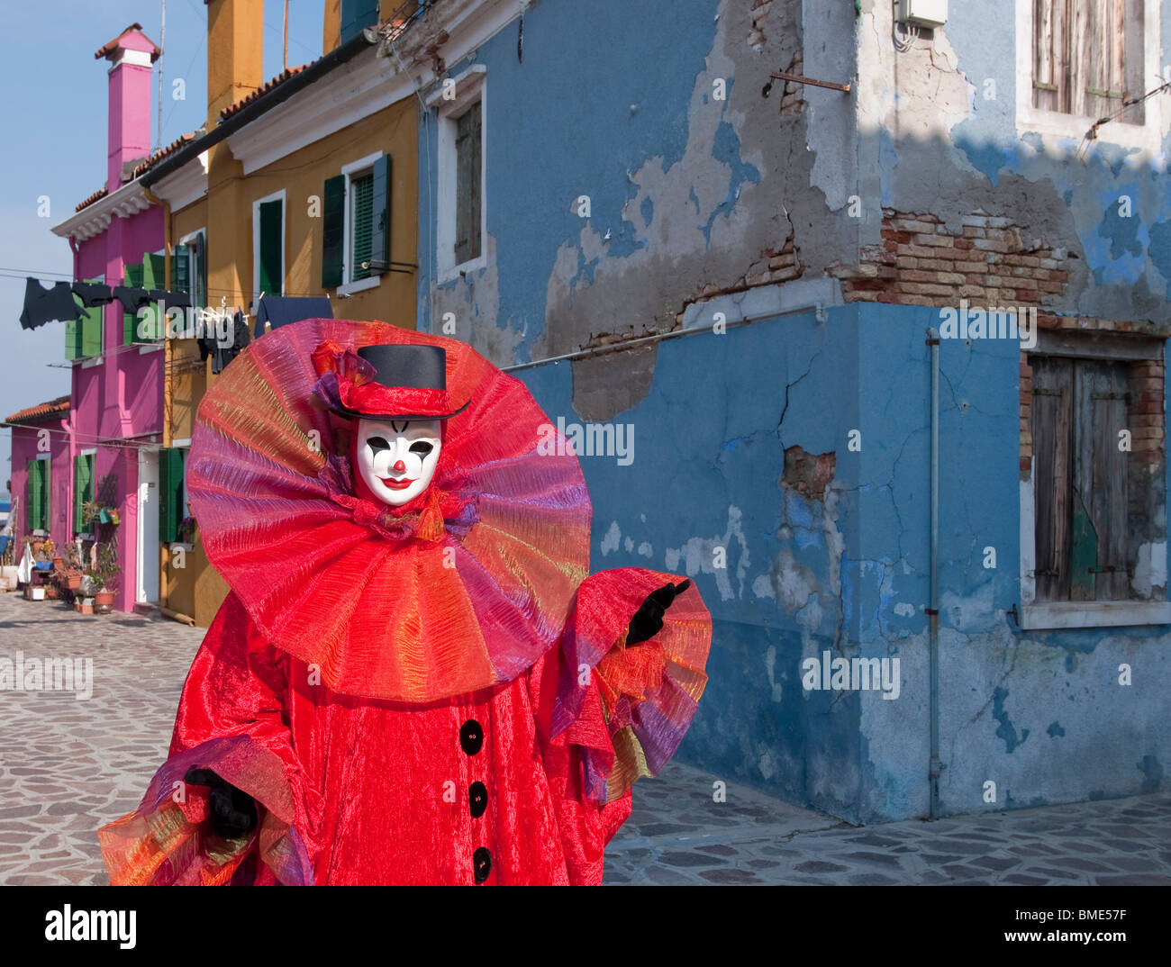 Clown walking the streets of Burano, Italy during the Venice Carnival ...