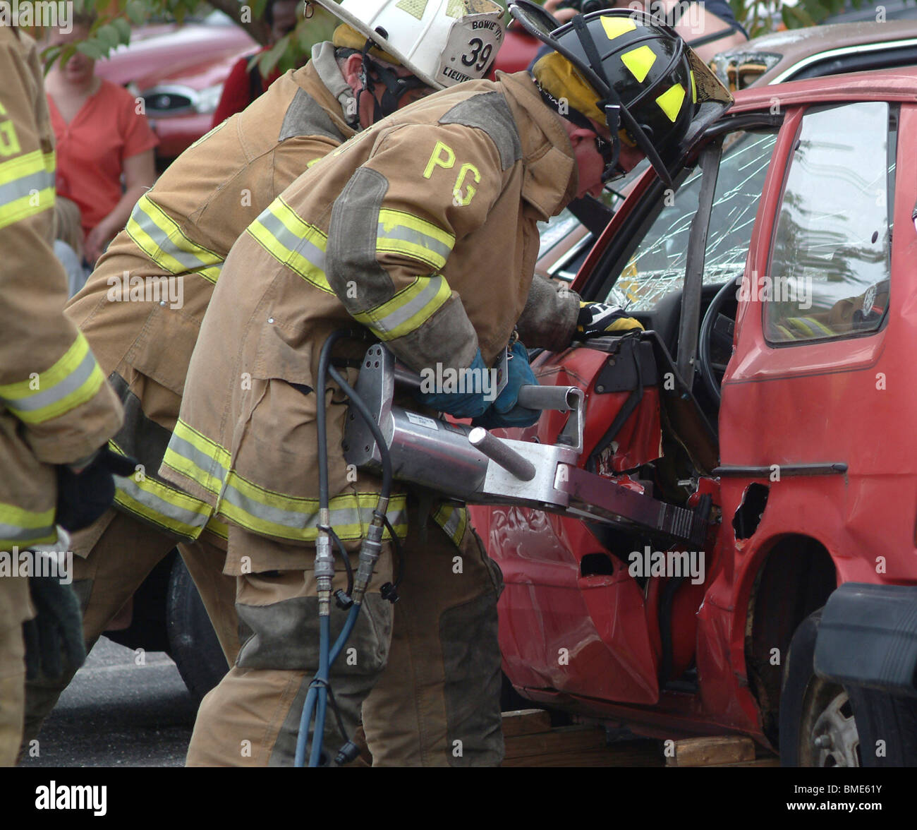 Firefighters work to extricate a man from a car accident Stock Photo - Alamy