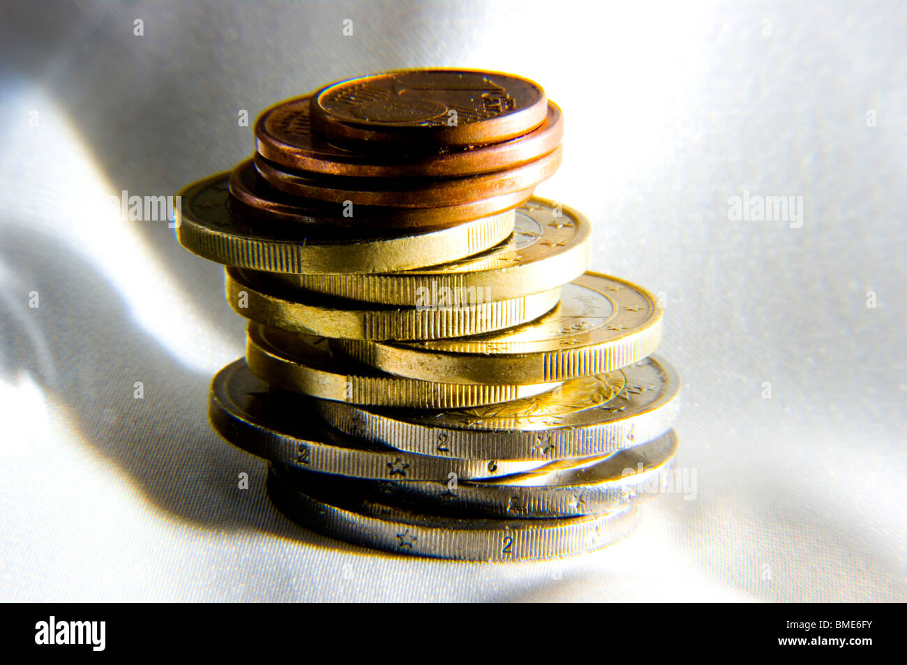 Macro of a stack of coins of euro descending order of magnitude. White ...