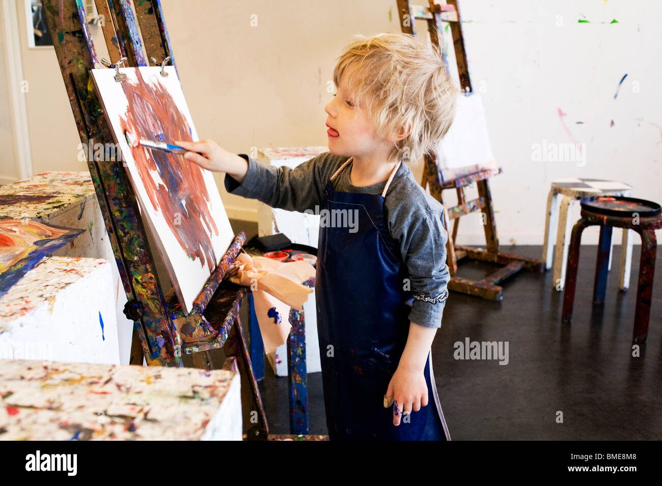 Children concentrate while painting hi-res stock photography and images ...