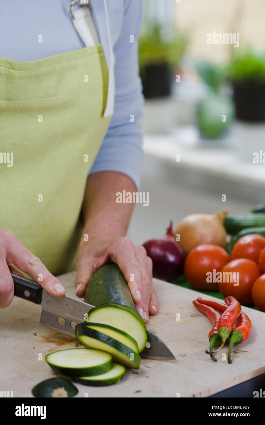 Woman cutting up vegetables, Sweden Stock Photo - Alamy