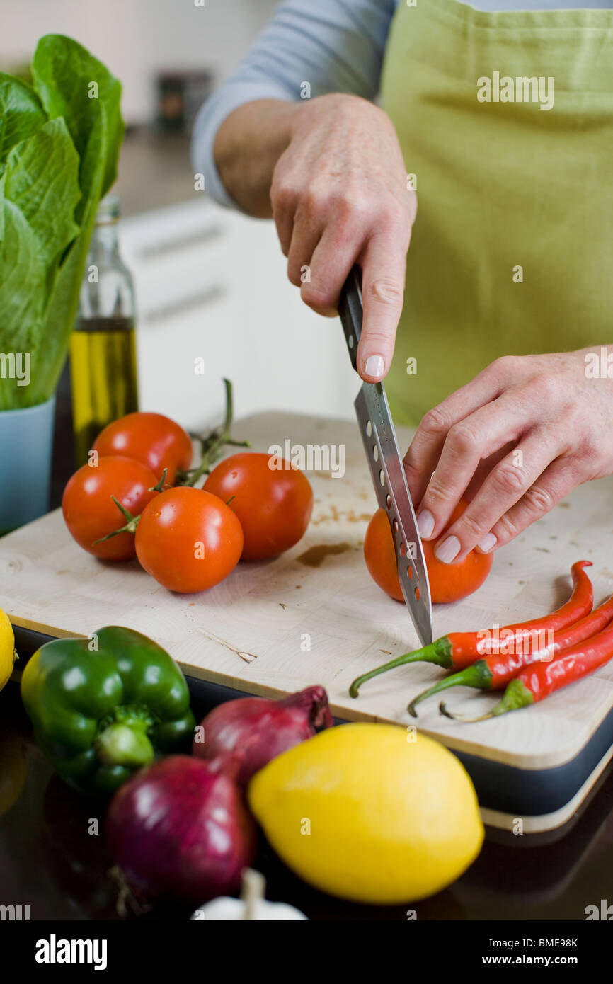 Woman cutting up vegetables, Sweden Stock Photo - Alamy