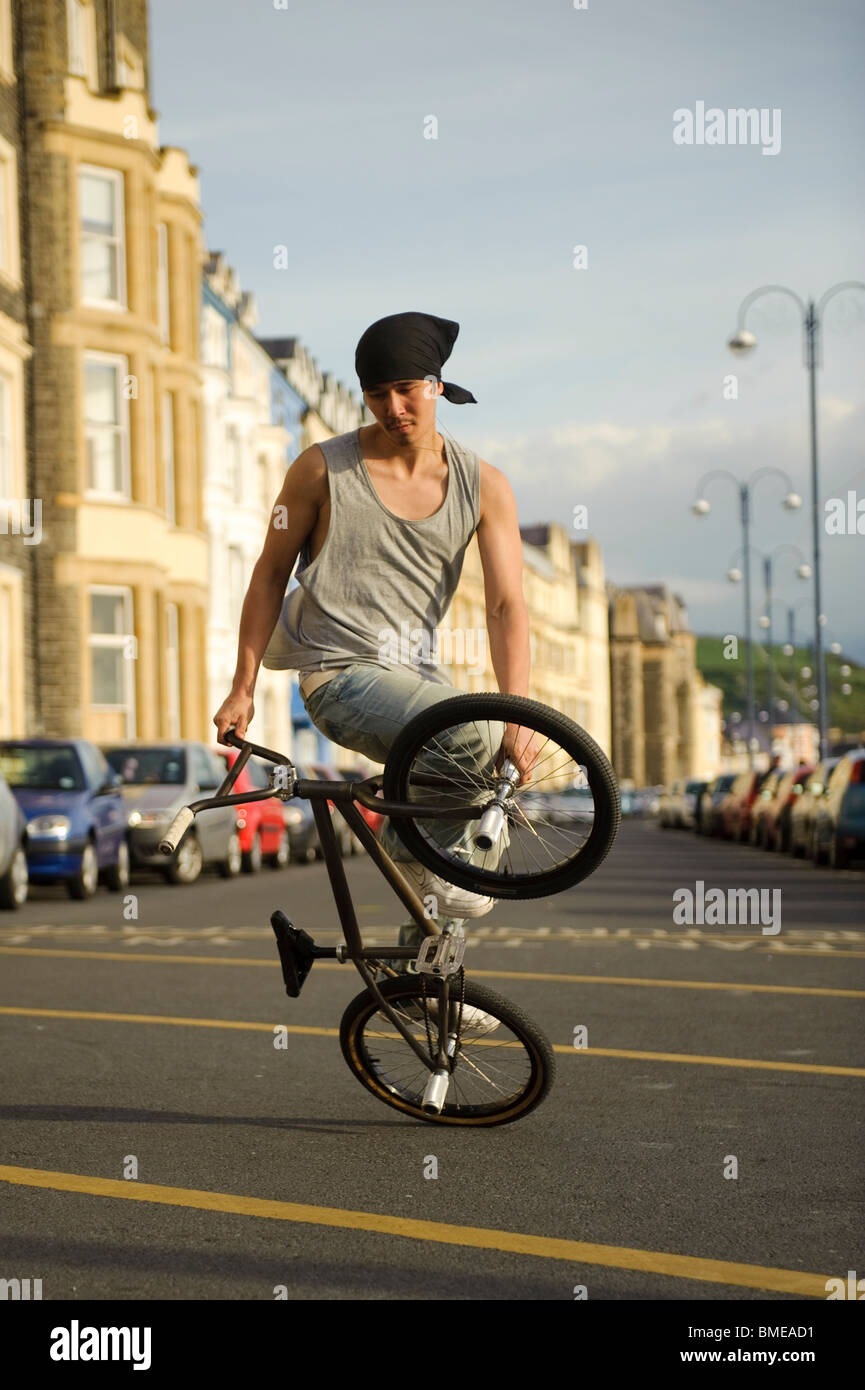 BMX flatland freestyle stunt rider young man performing stunts on his ... BMX flatland freestyle stunt rider young man performing stunts on his ...