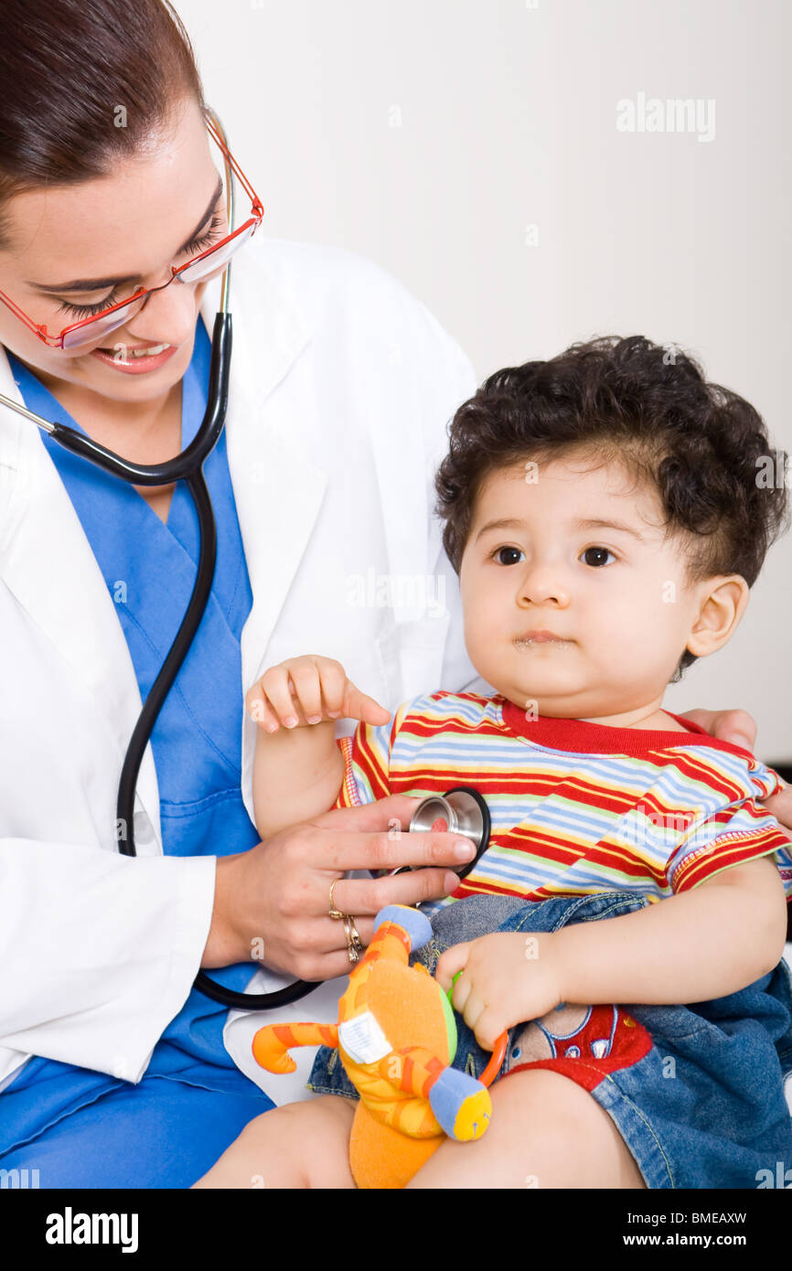 female doctor examining cute baby Stock Photo - Alamy